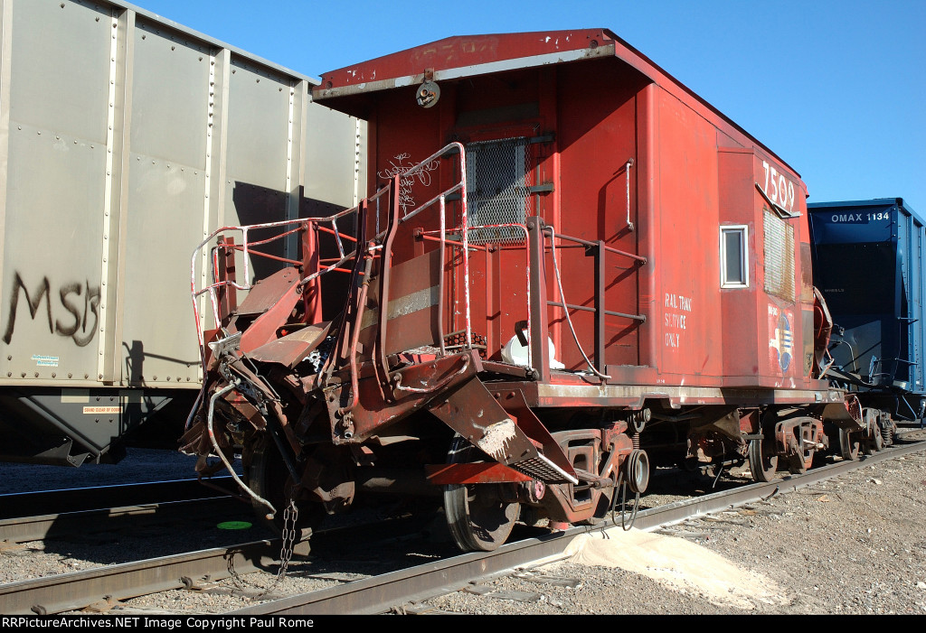 MP 7509, ex MoPac caboose damaged in a runaway collision of UP 9366 and between OMAX 1134 hopper
